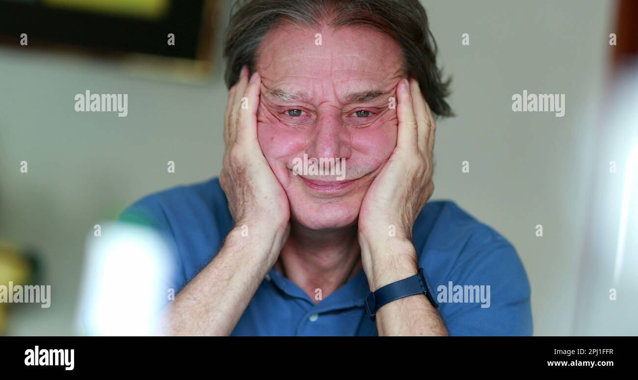 Senior man covering face with hands, older retired man rubbing face ...