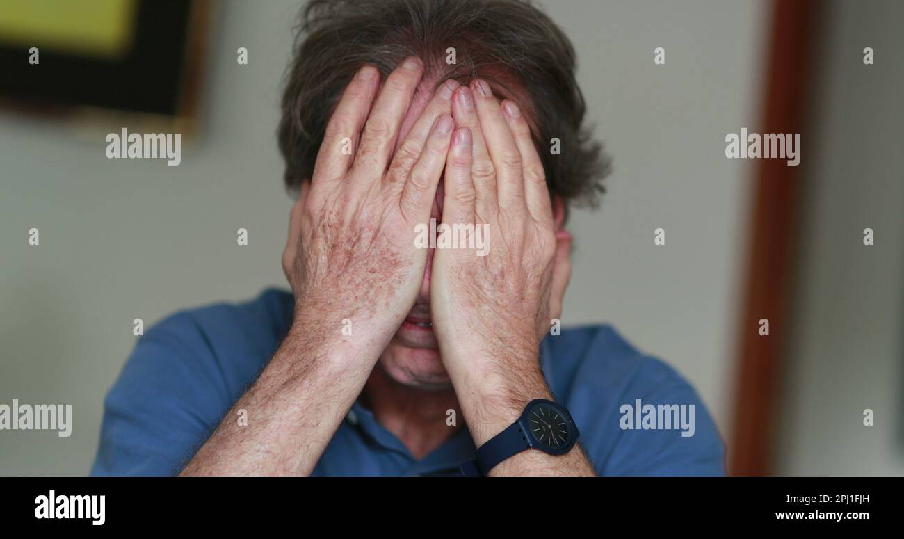 Stressed older man covering face with hands.Senior person feeling pain ...