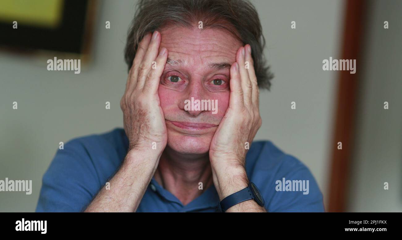 Stressed older man covering face with hands.Senior person feeling pain ...