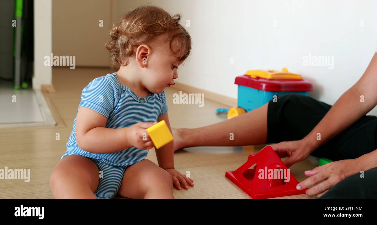 Successful baby clapping hands. One year old infant child solving ...