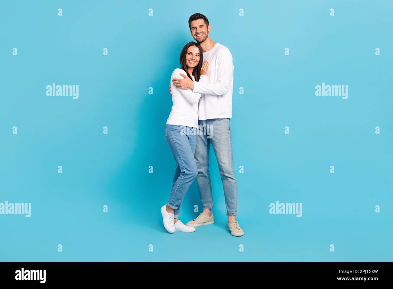 Full length portrait of two cheerful nice partners hugging toothy smile ...