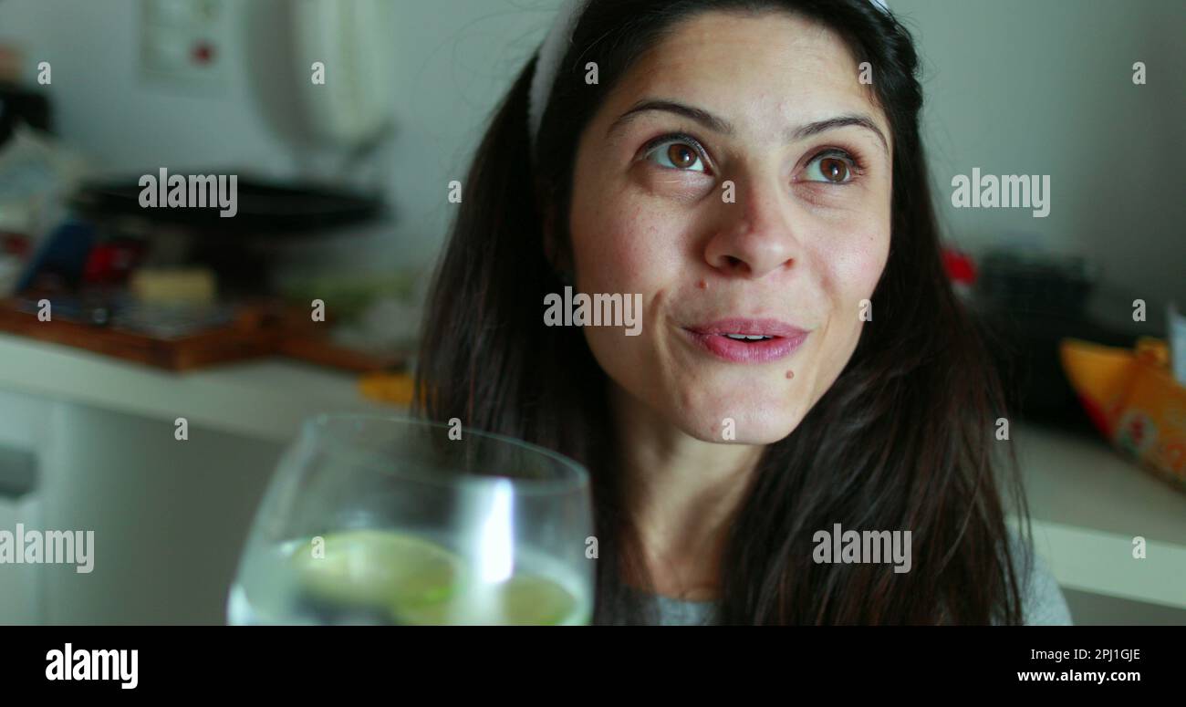Woman talking while holding drink gin and tonic, relaxing during ...