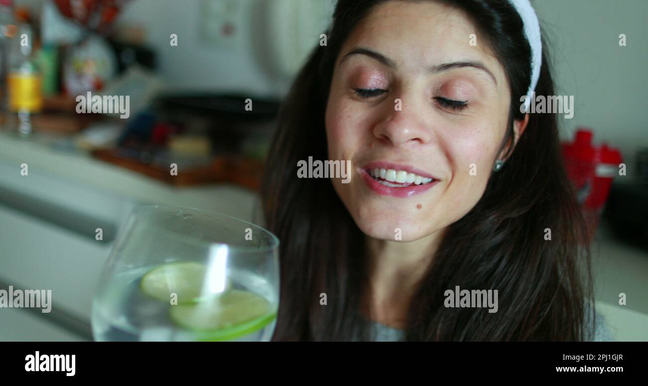 Woman talking while holding drink gin and tonic, relaxing during ...