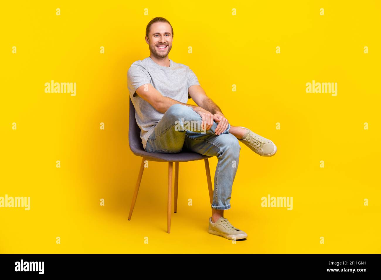 Full size photo pleasant friendly man dressed gray t-shirt denim pants ...