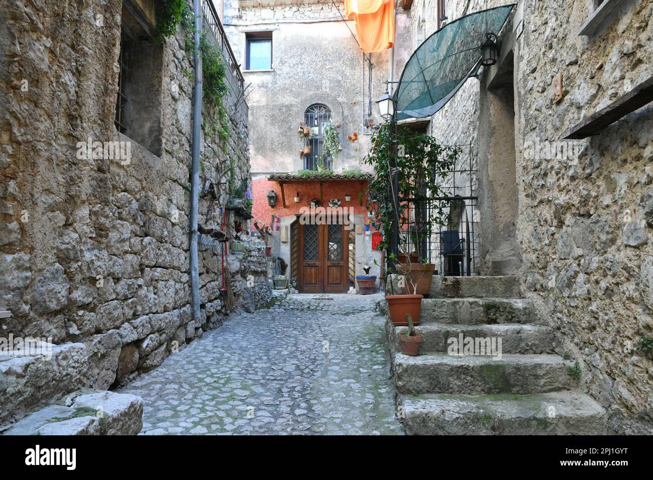 A narrow street among the old houses of Fumone, a historic town in the ...