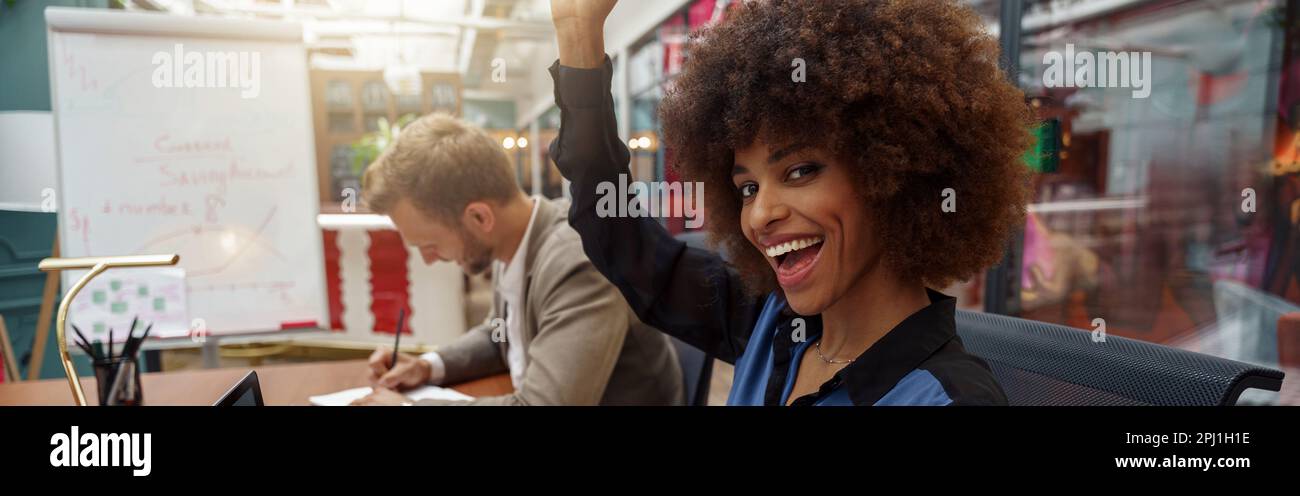 Happy african businesswoman sitting on his workplace in modern office ...