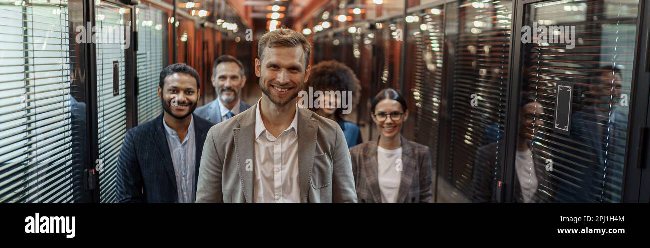 Group of happy, motivated business people standing together at office ...