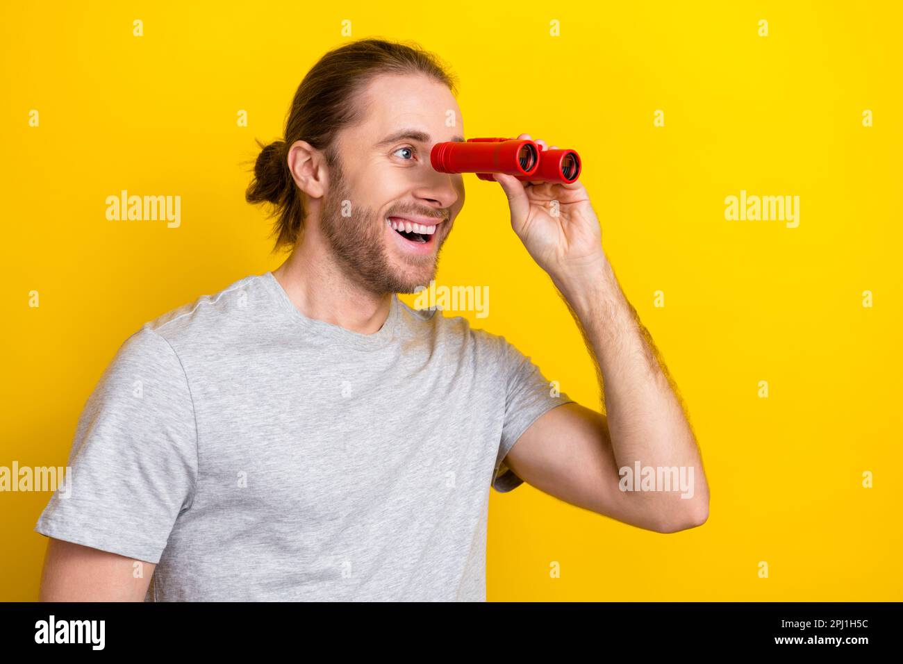 Photo of funny funky guy dressed grey t-shirt looking binoculars emtpy ...