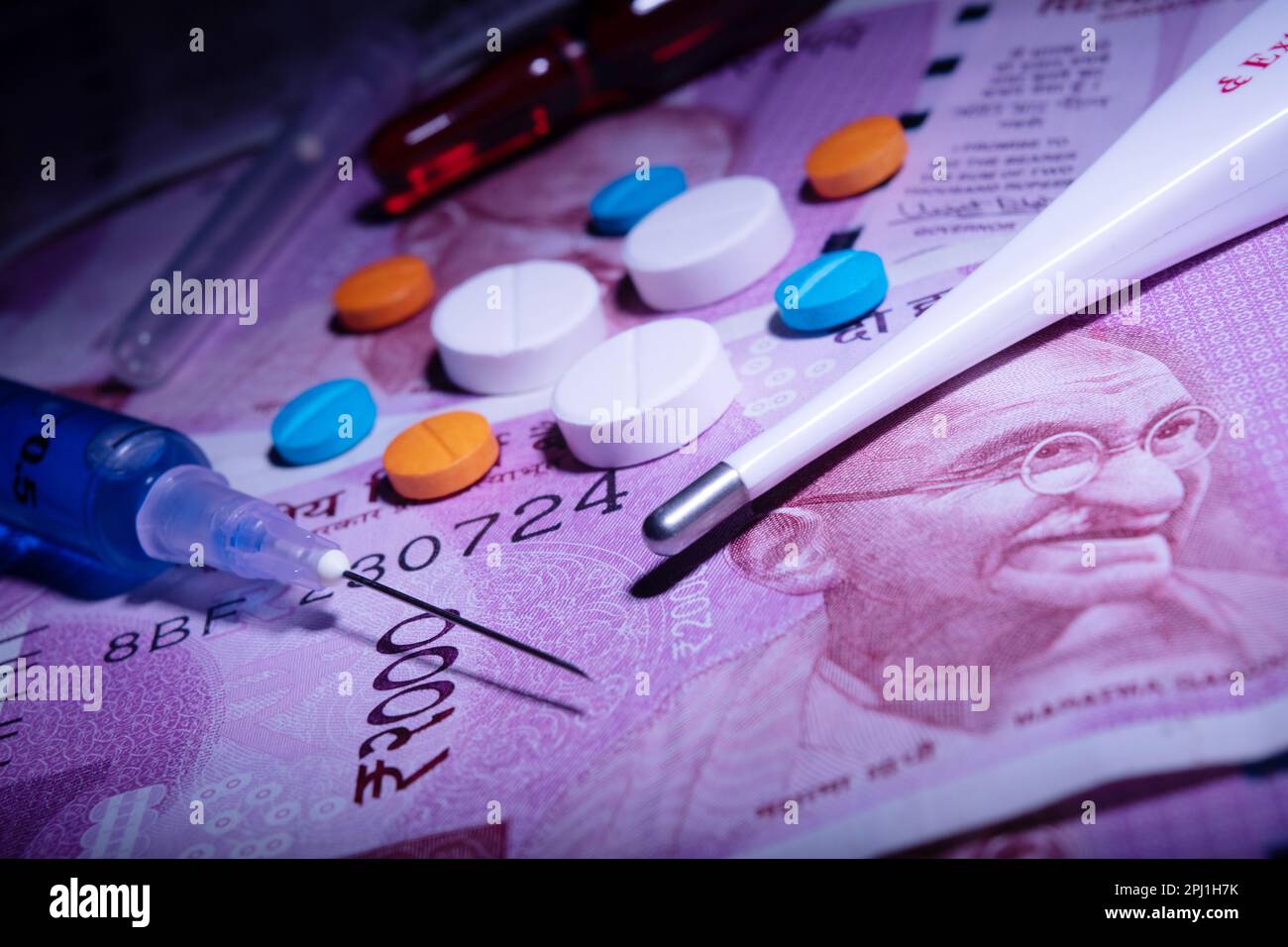Indian currency with medicine and injection Stock Photo - Alamy
