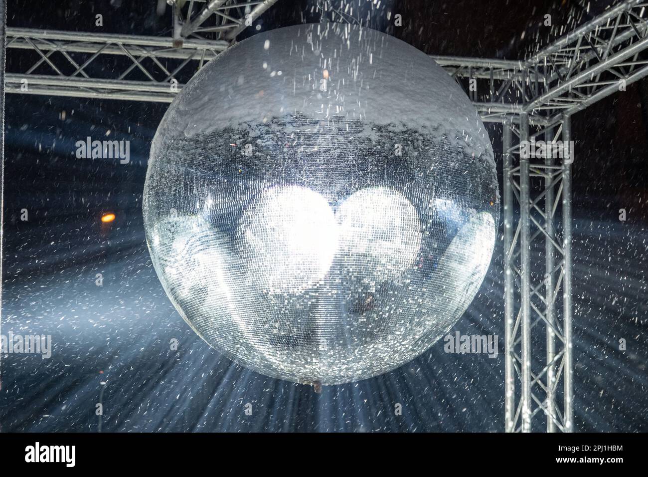 A large disc ball that reflects blue light. Disco symbol. Snow flake ...