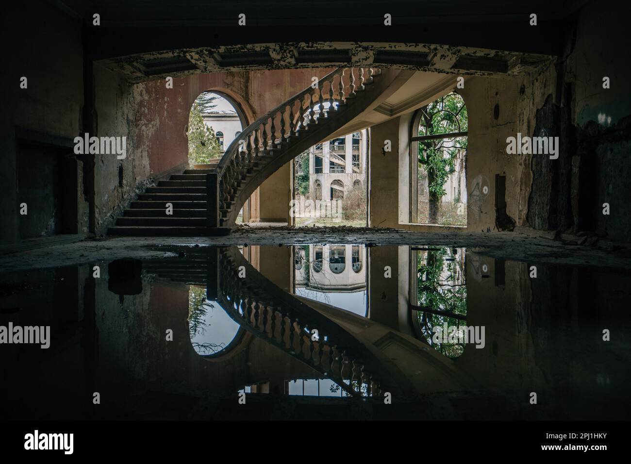 Old flooded abandoned mansion with spiral stair, water reflection Stock ...