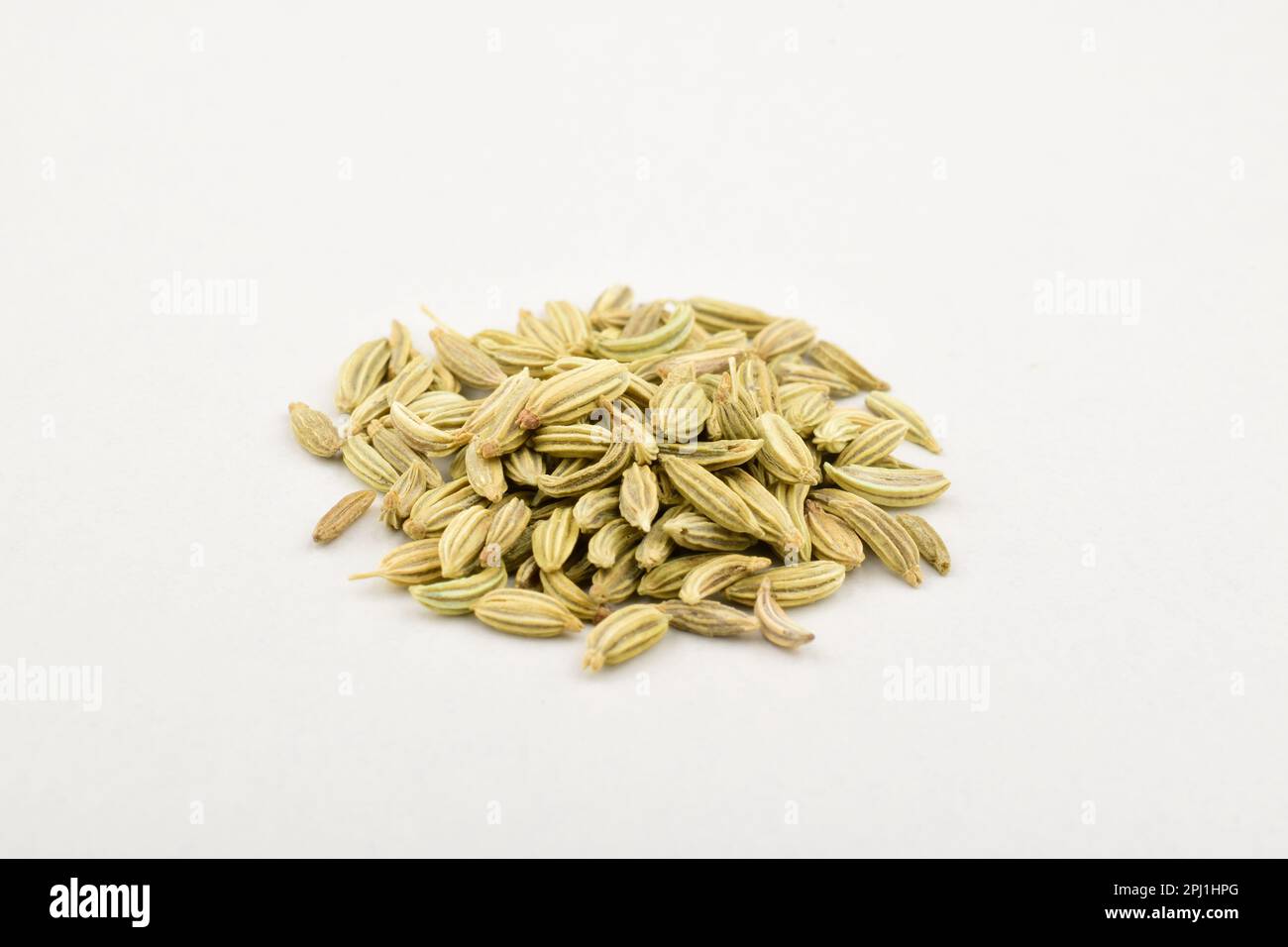 Closeup of fennel seeds on white background Stock Photo - Alamy