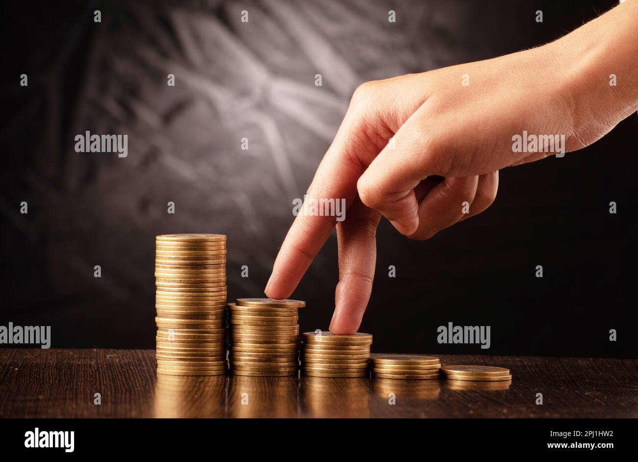 finger stepping towards coin stack money making concept Stock Photo - Alamy