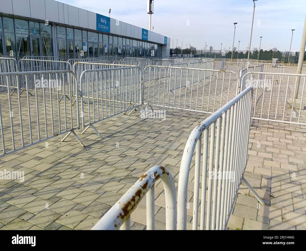 Metal mobile barriers near the stadium. Entrance with the inscription ...