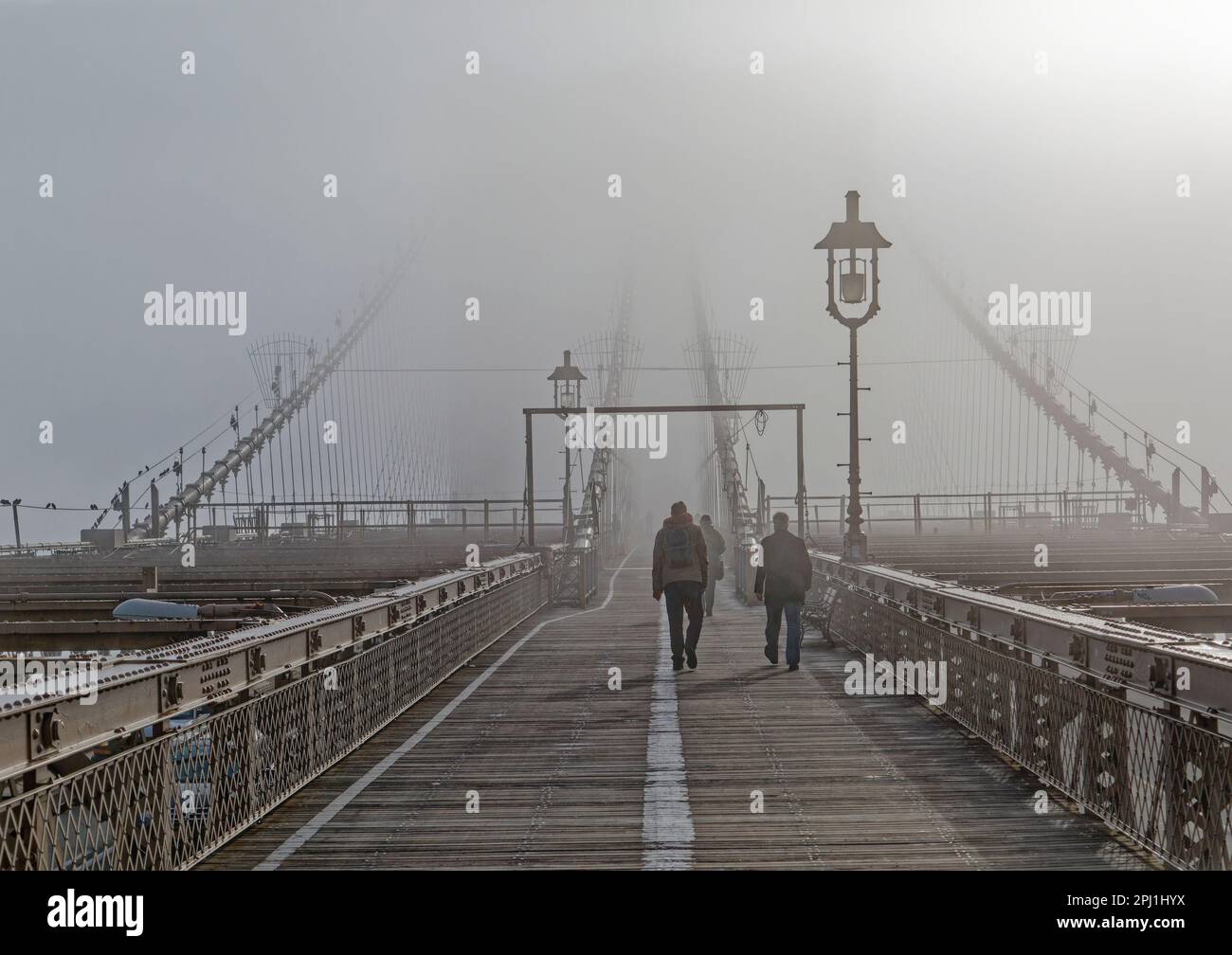 Brooklyn Bridge’s famous gothic towers are shrouded in a January fog ...