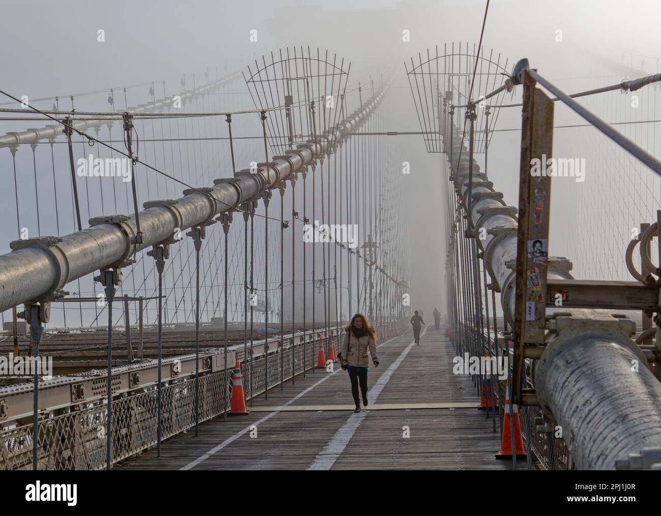 Brooklyn Bridge’s famous gothic towers are shrouded in a January fog ...