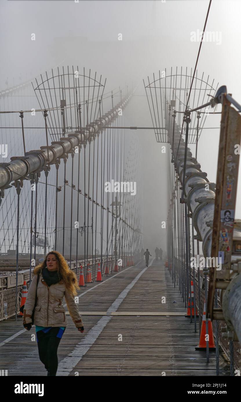 Brooklyn Bridge’s famous gothic towers are shrouded in a January fog ...