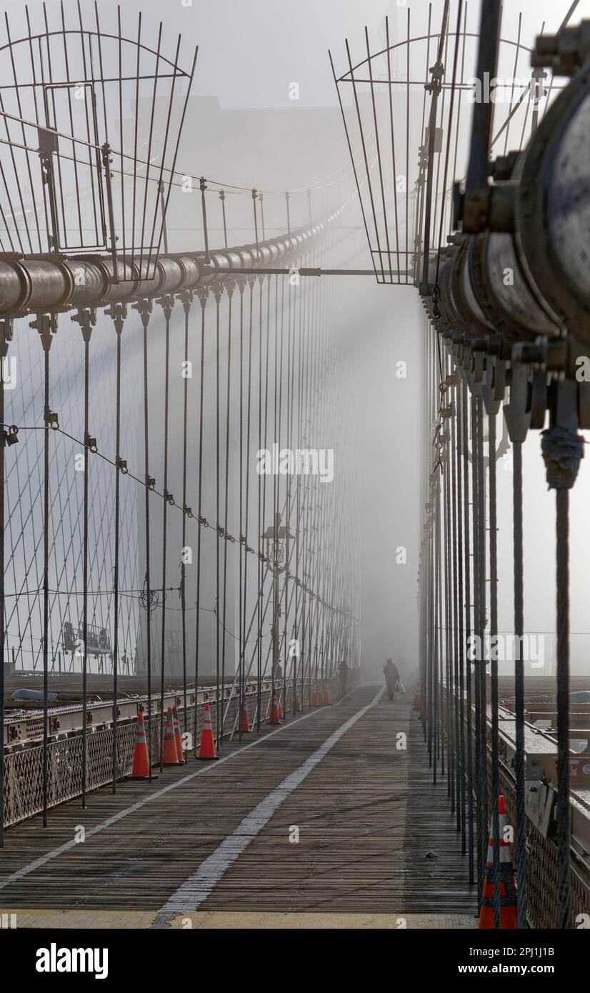 Brooklyn Bridge’s famous gothic towers are shrouded in a January fog ...