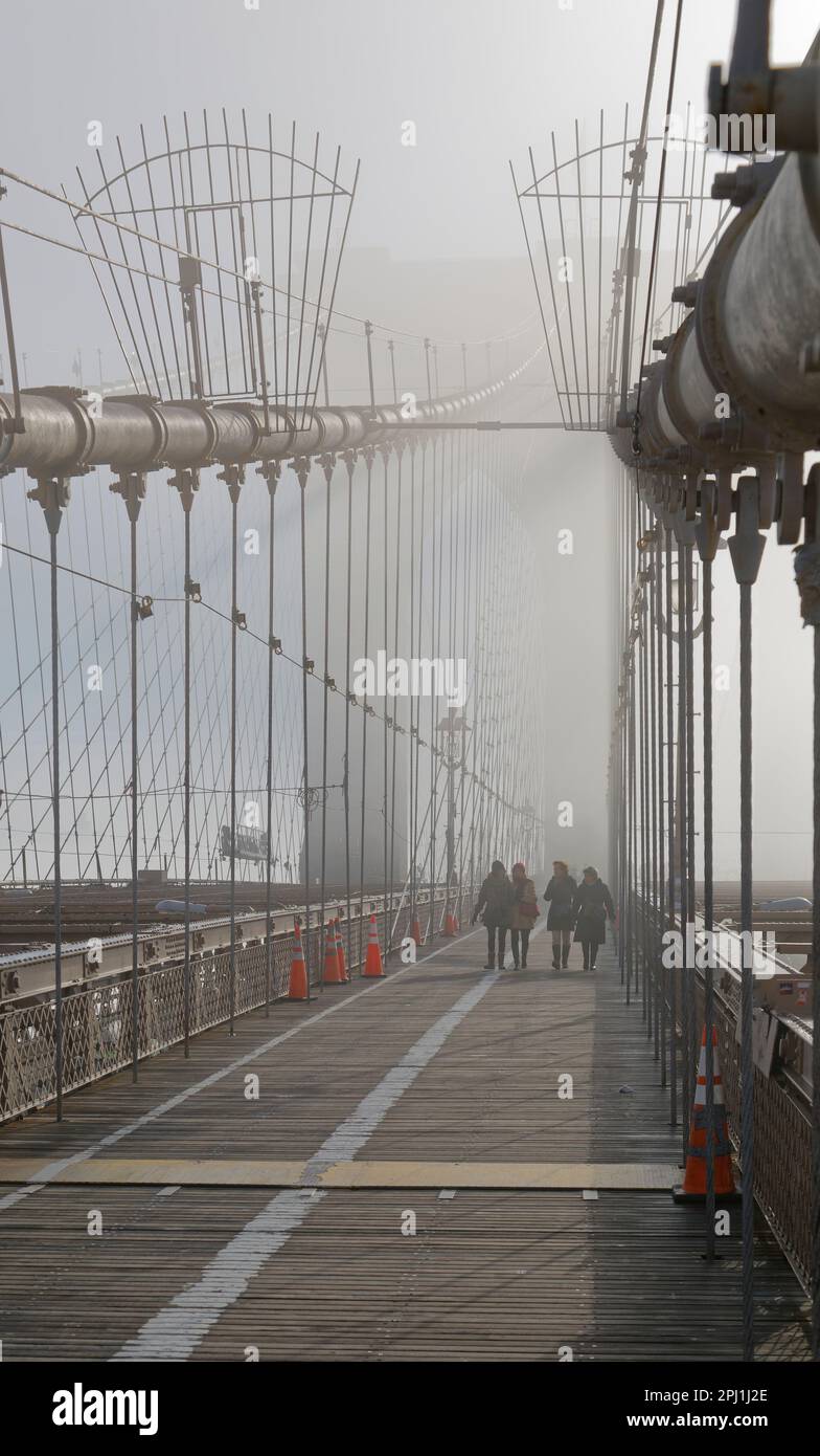 Brooklyn Bridge’s famous gothic towers are shrouded in a January fog ...