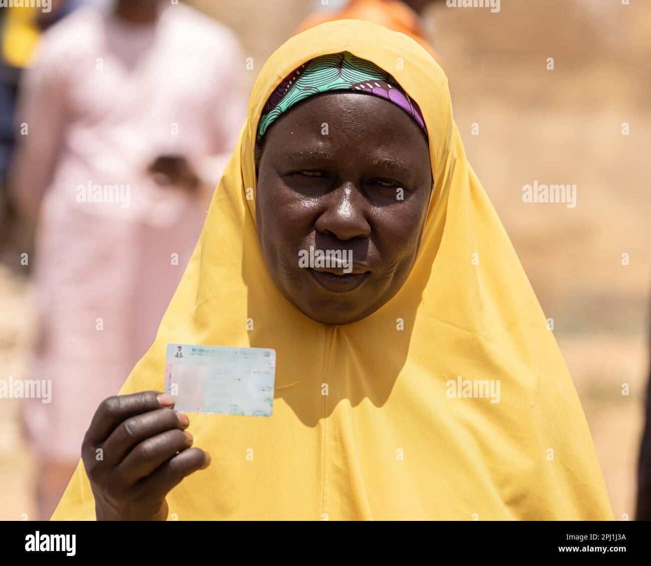 A woman displays her voters card during the gubernatorial election in Kano, Nigeria Stock Photo ...