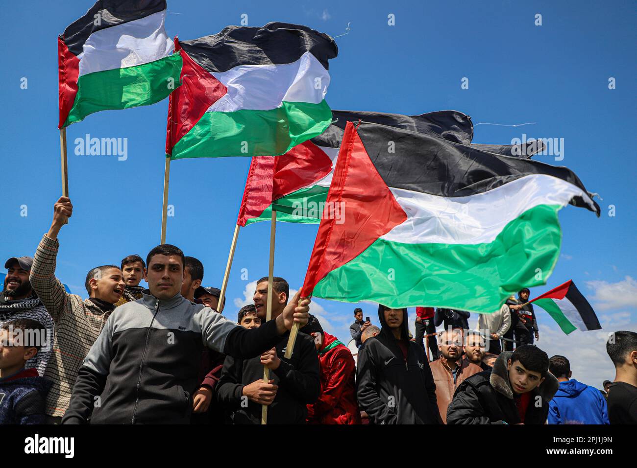 Gaza. 30th Mar, 2023. Palestinians hold national flags to mark the Land ...