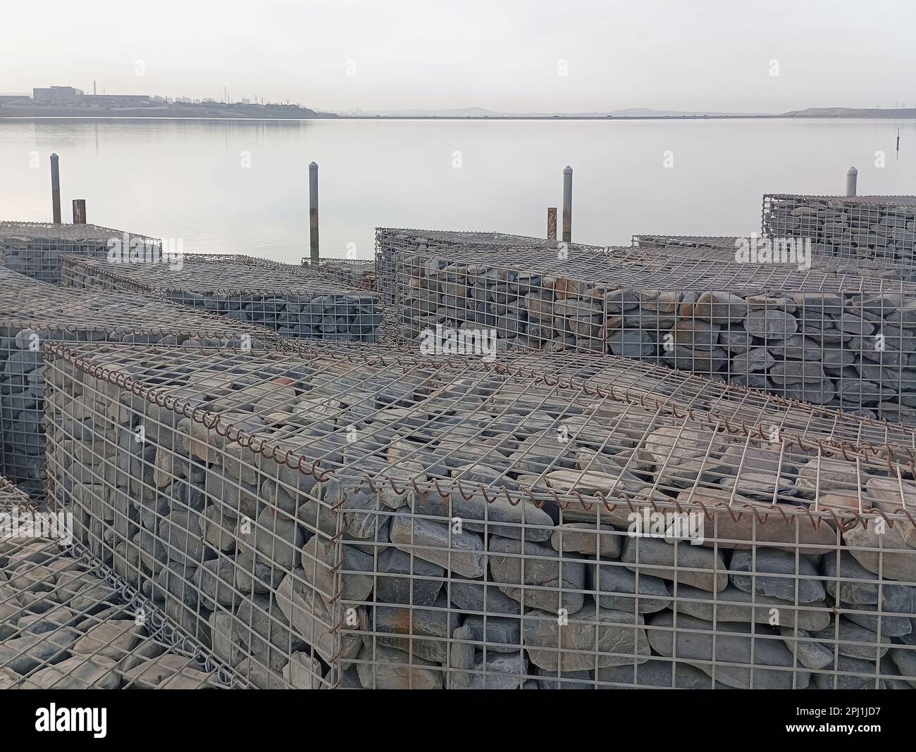 Modern structures made of stones and metal rods on salt lake Boyukshor ...