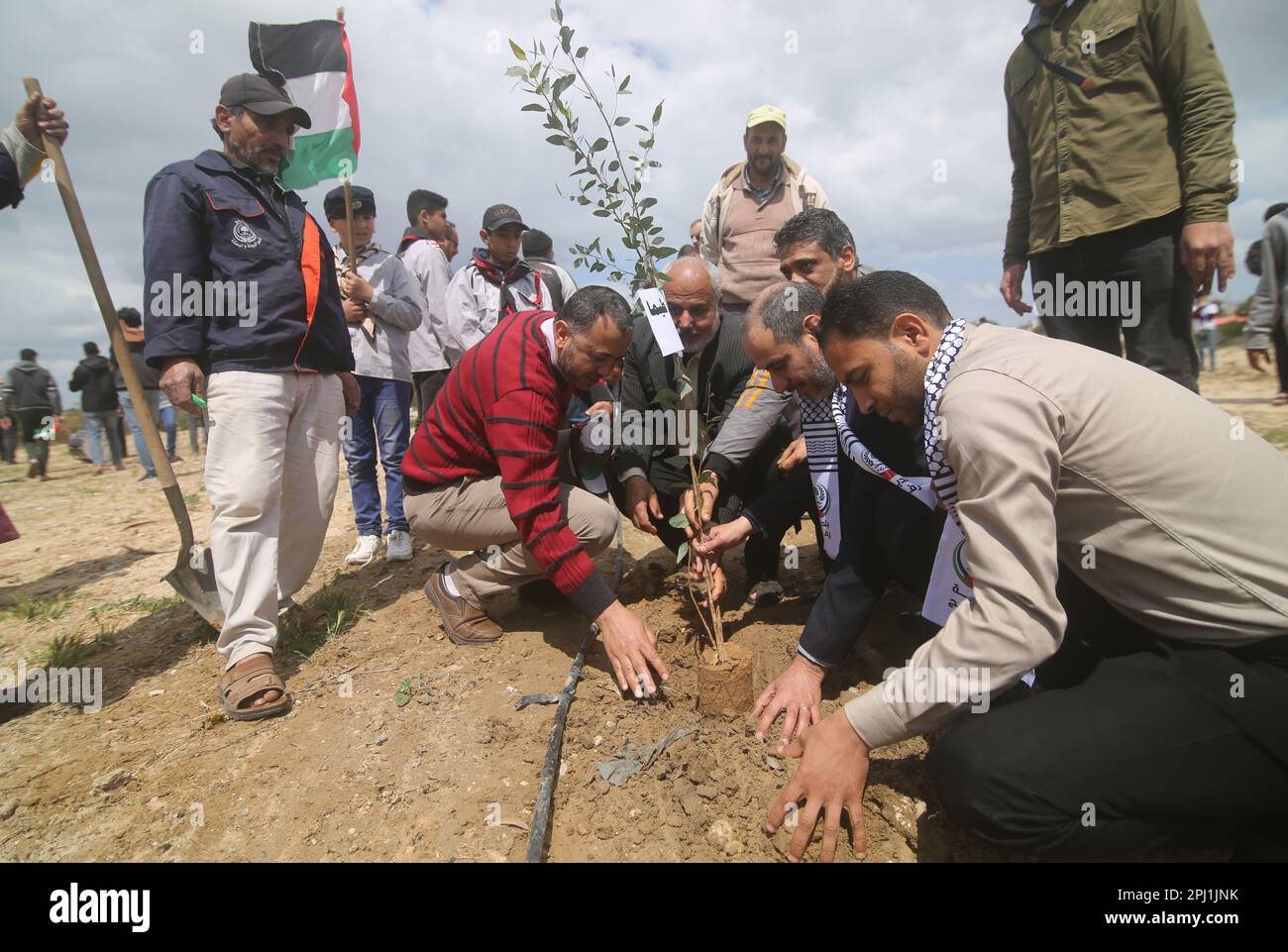 Gaza. 30th Mar, 2023. Palestinians plant a tree during an event marking ...