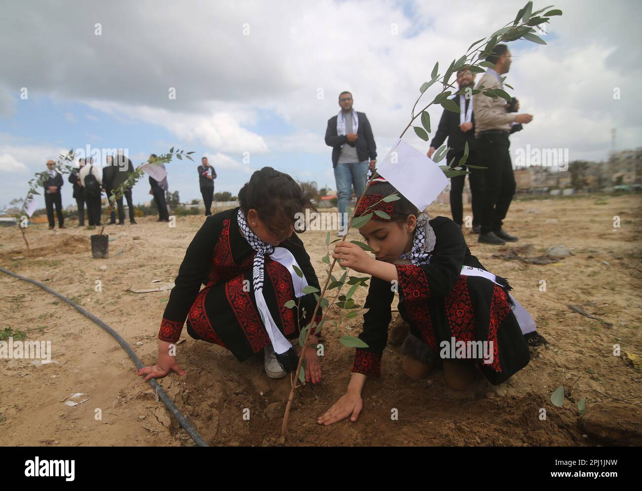Gaza. 30th Mar, 2023. Palestinians plant a tree during an event marking ...