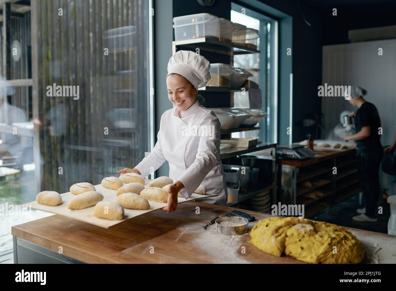 A woman baker making of traditional yeast buns with cheese Stock Photo ...