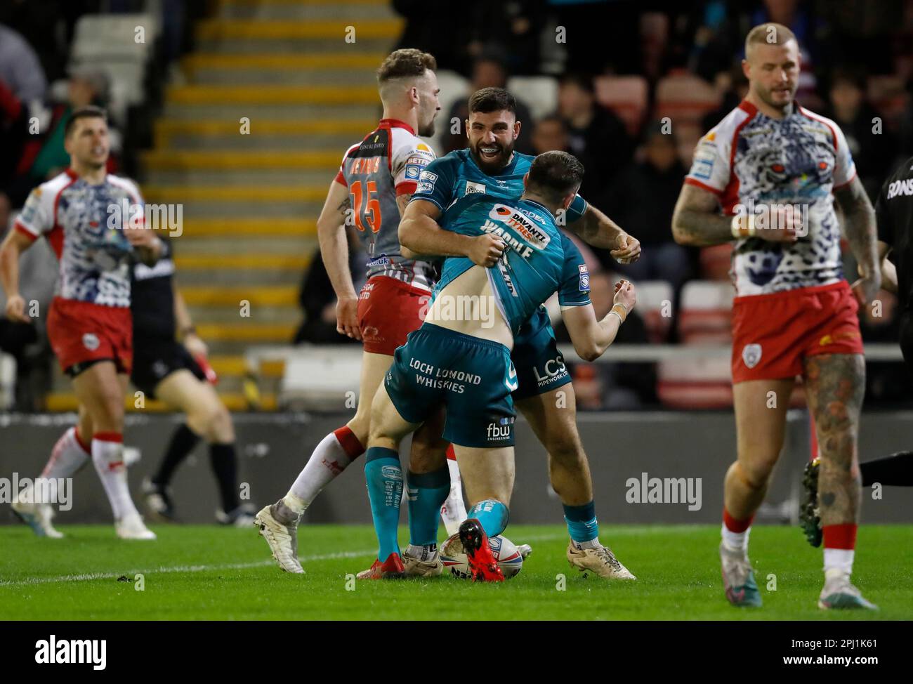 Wigan Warriors' Jake Wardle (centre left) celebrates with Abbas Miski ...
