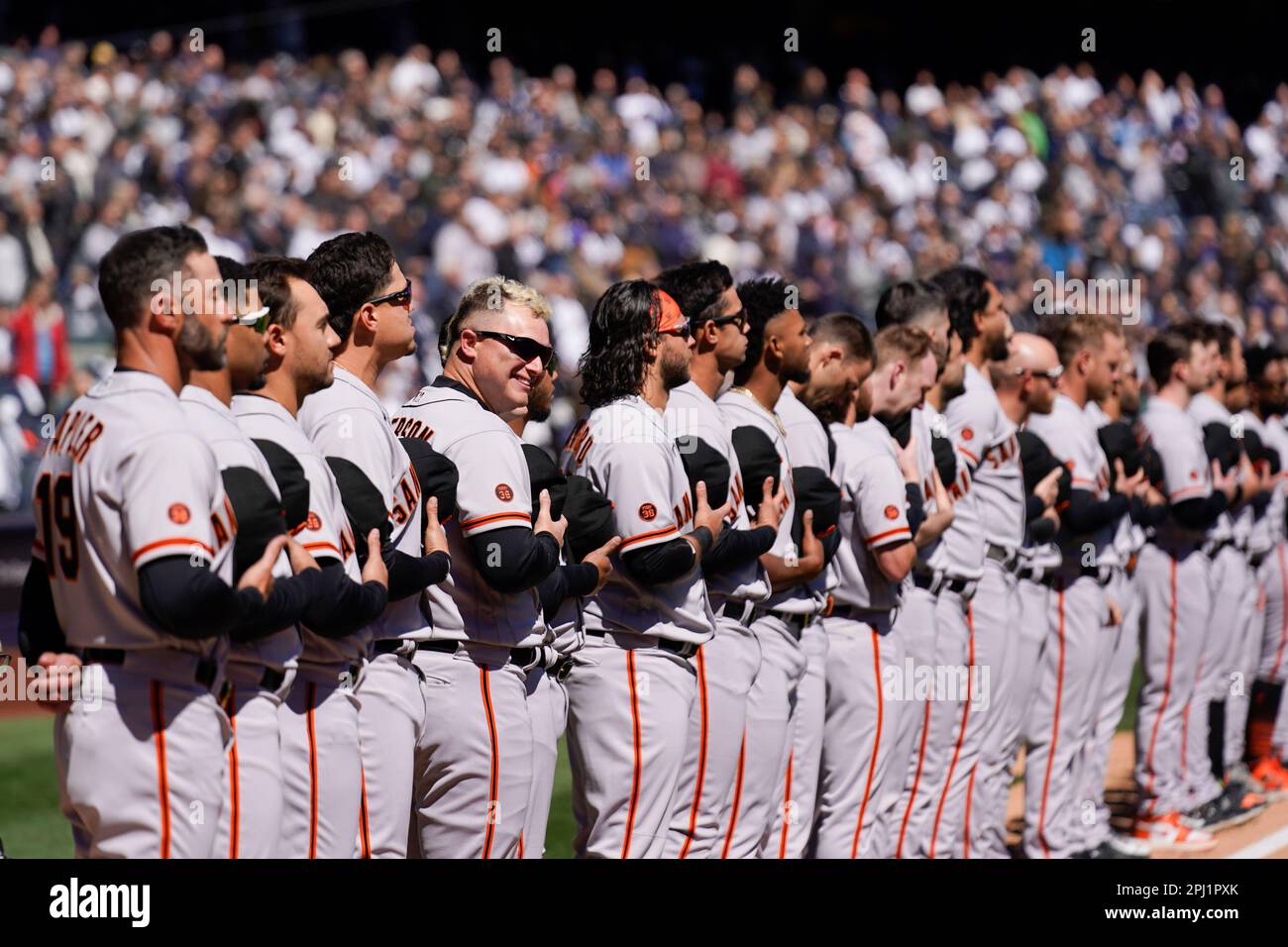 The San Francisco Giants line-up for the National Anthem before the ...