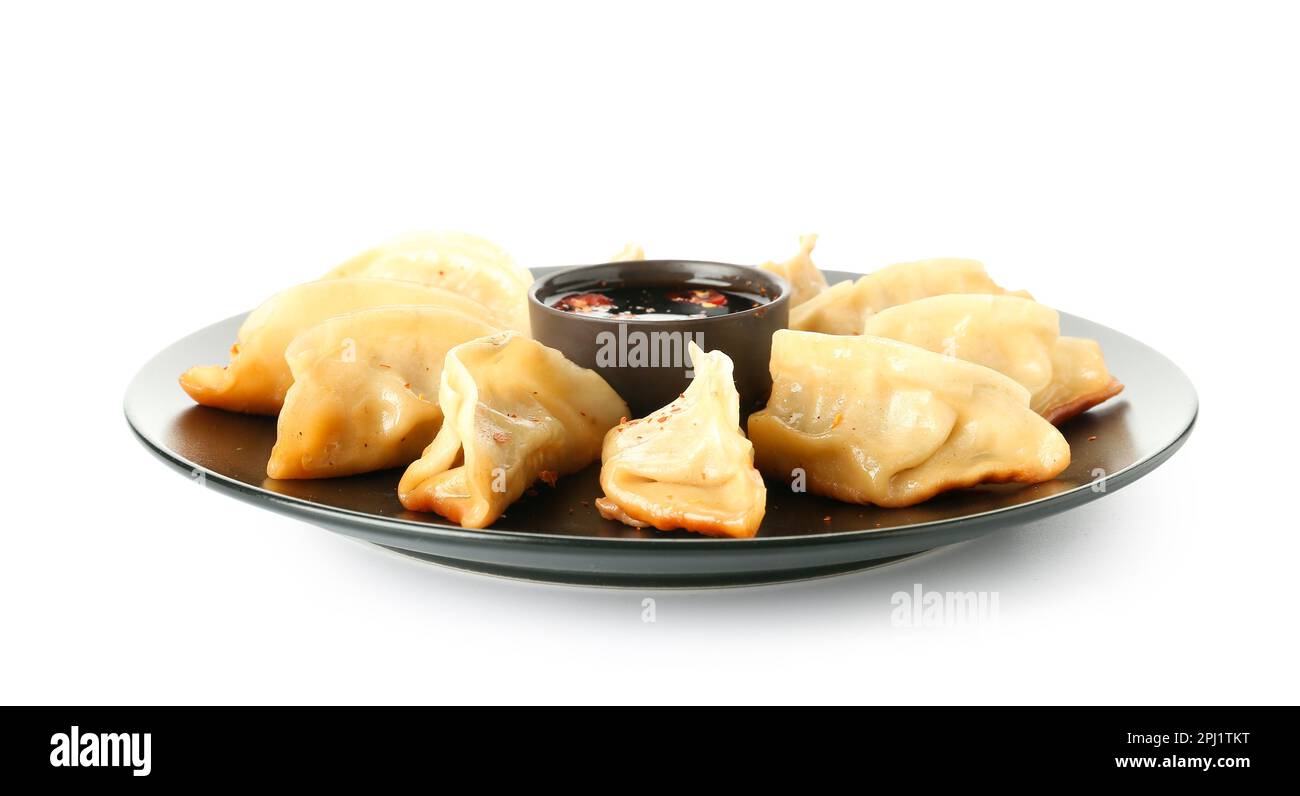 Plate with tasty Chinese jiaozi and sauce on white background Stock Photo - Alamy