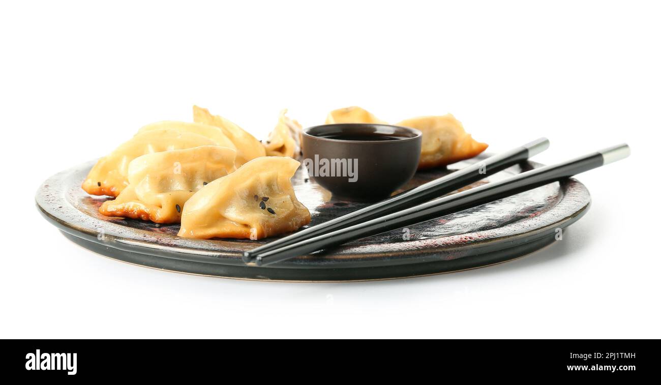 Plate with tasty Chinese jiaozi and sauce on white background Stock Photo - Alamy