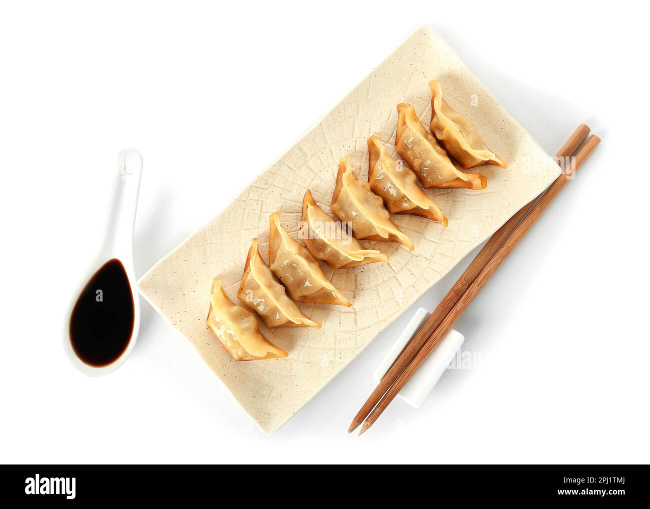 Plate with tasty Chinese jiaozi and sauce on white background Stock Photo - Alamy