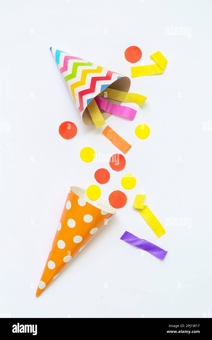 Party hats with confetti on white background Stock Photo - Alamy
