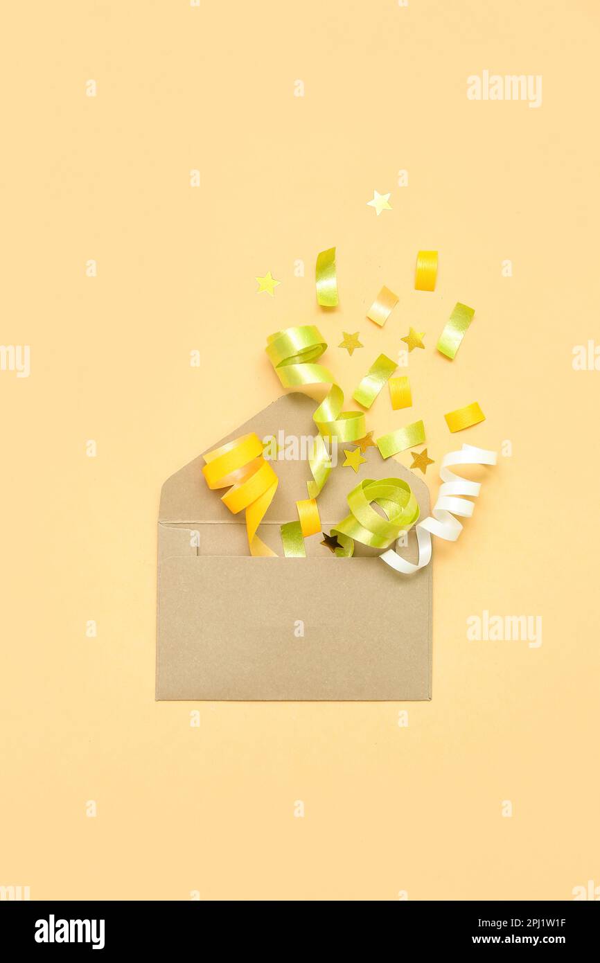 Composition with envelope and confetti on yellow background Stock Photo ...