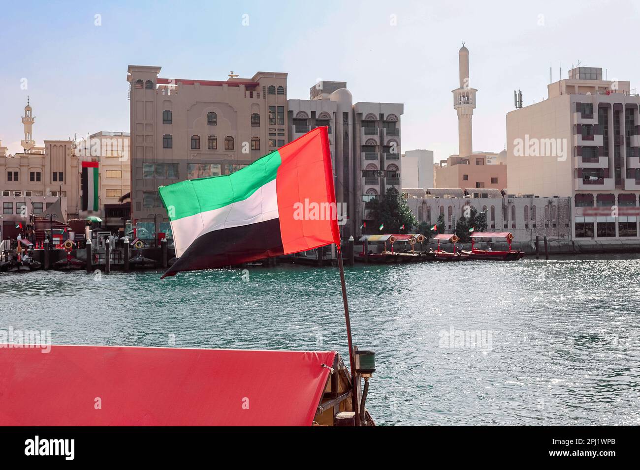 Big flag of United Arab Emirates flying high on city of Dubai in old ...