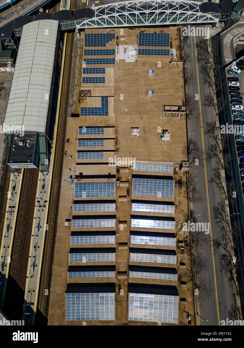 An overhead aerial view of a large building surrounded by railway ...