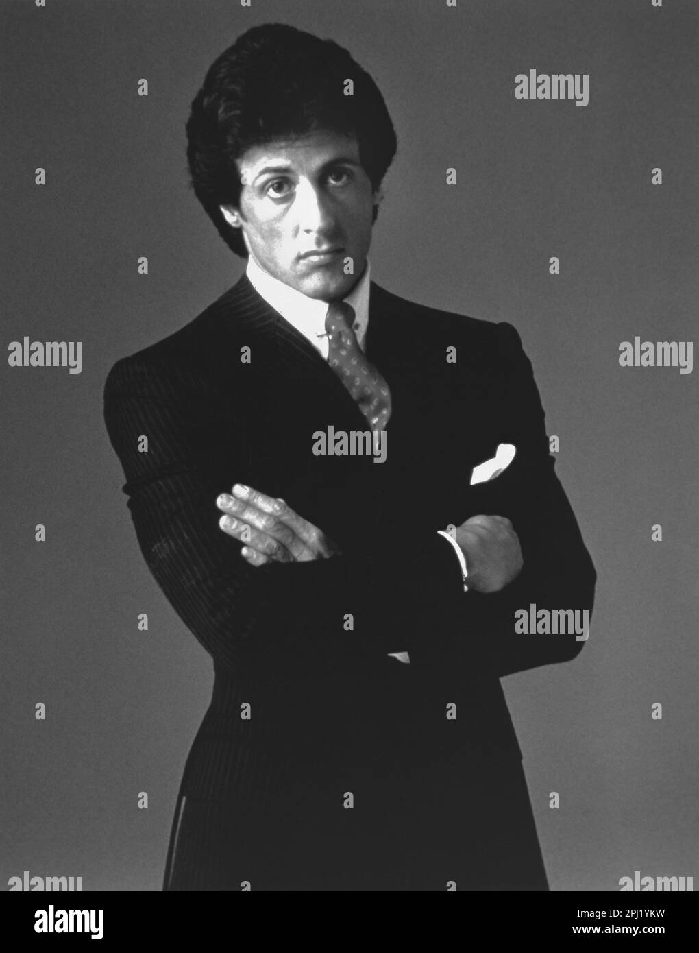 PR shot of Sylvester Stallone in a suit and tie from movie franchise ...