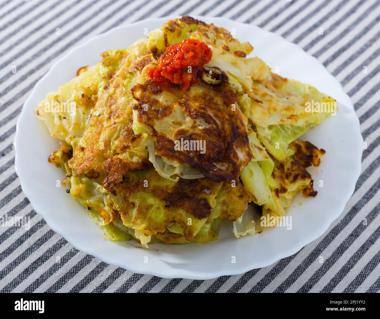 Photography of plate with cabbage leaves in batter Stock Photo - Alamy