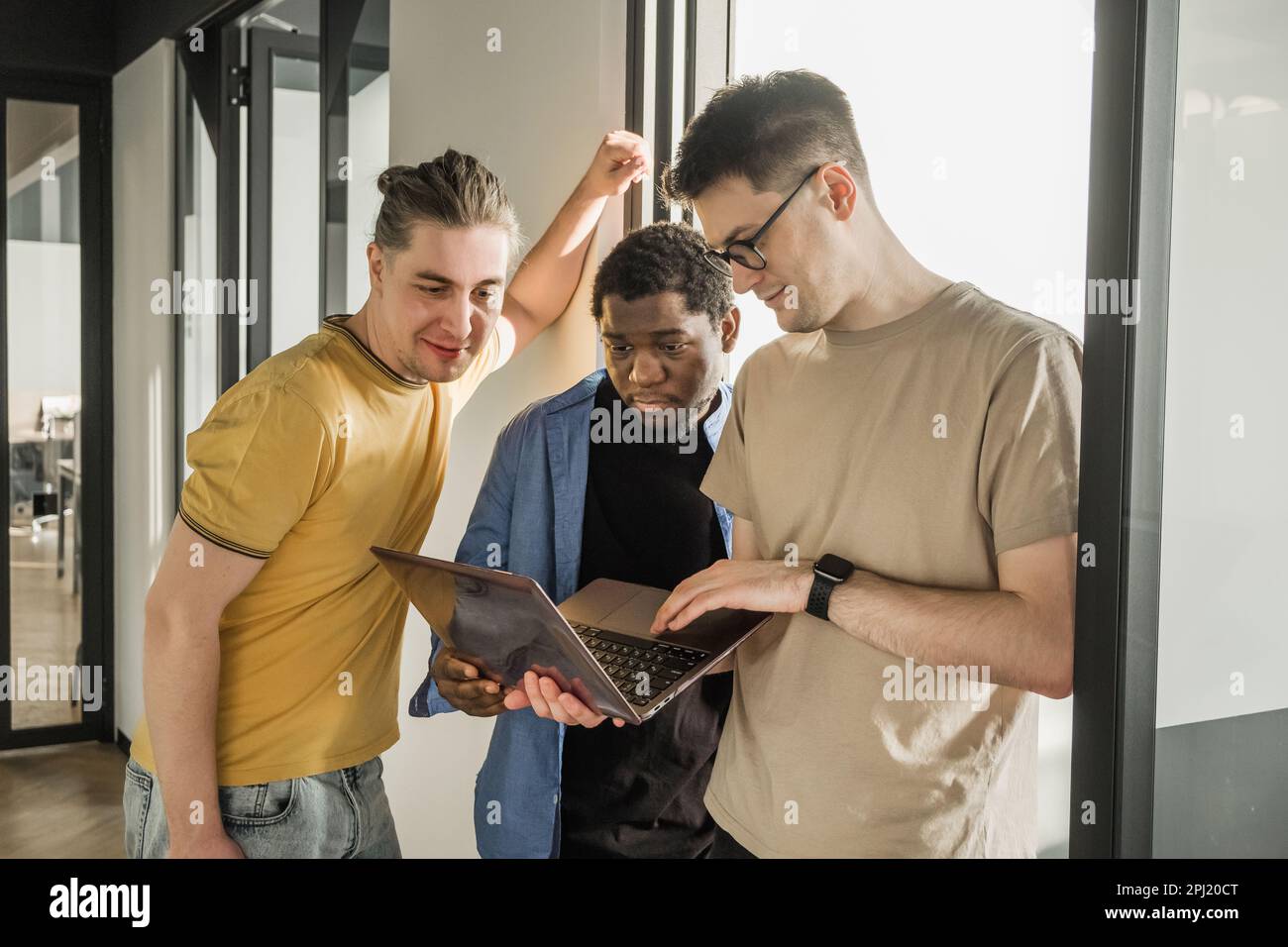 A young developer gives new project tasks to his partners. Business ...