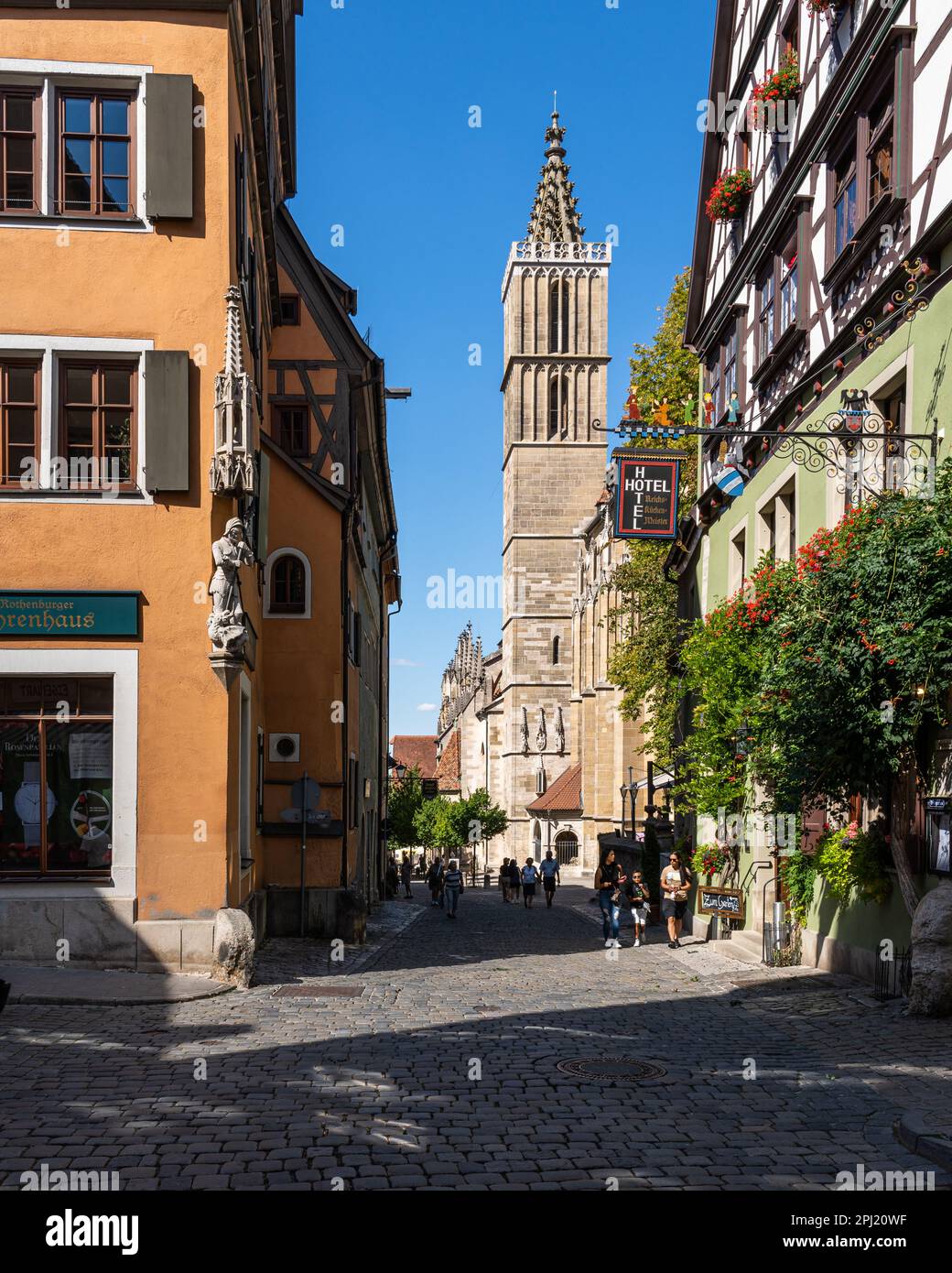 Pedestrian street of Rothenburg ob der Tauber with the bell tower of St ...