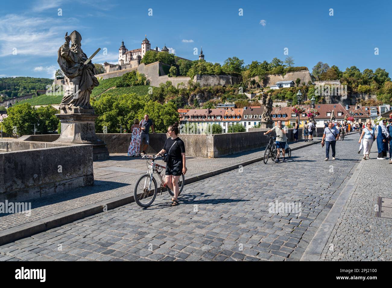 People enjoying a summer day at Wurzburg Old Bridge with Marienberg ...