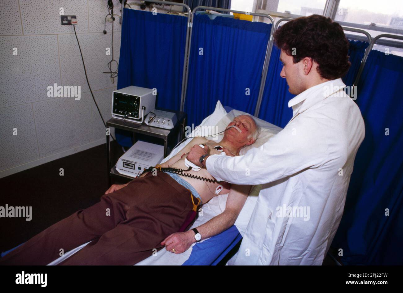 Doctor using Defibulator on Heart Attack Patient in Accident and ...