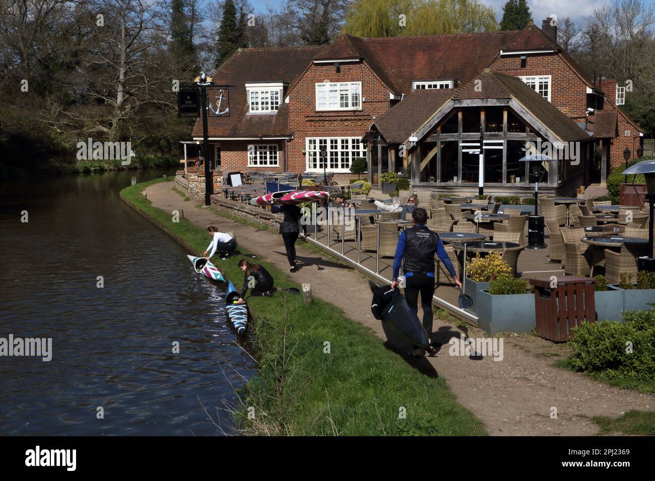 Canoeists by The Anchor Pub by Pyrford Lock on Banks of River Wey ...