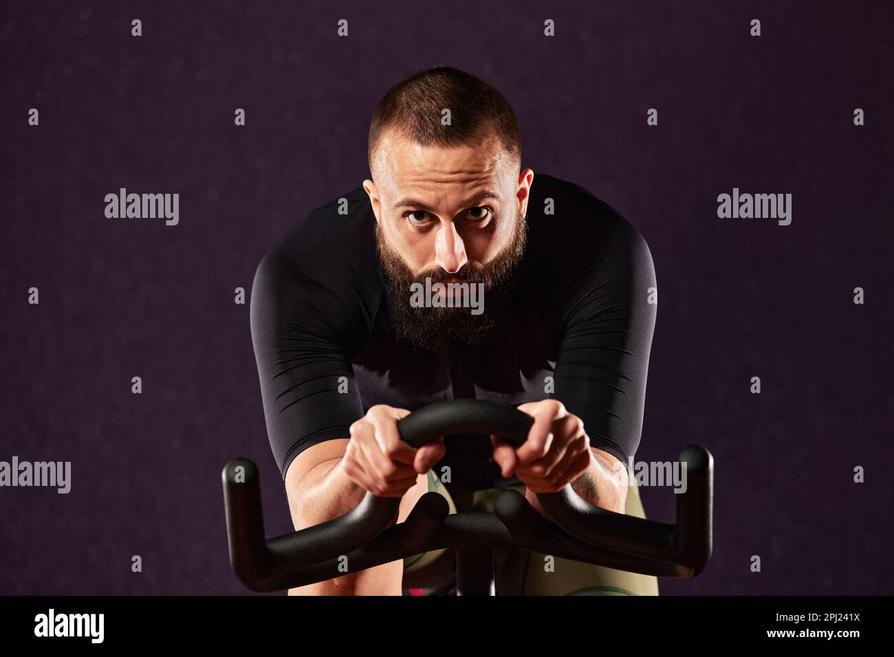 Close-up portrait of a cyclist on a dark background floor of the face ...