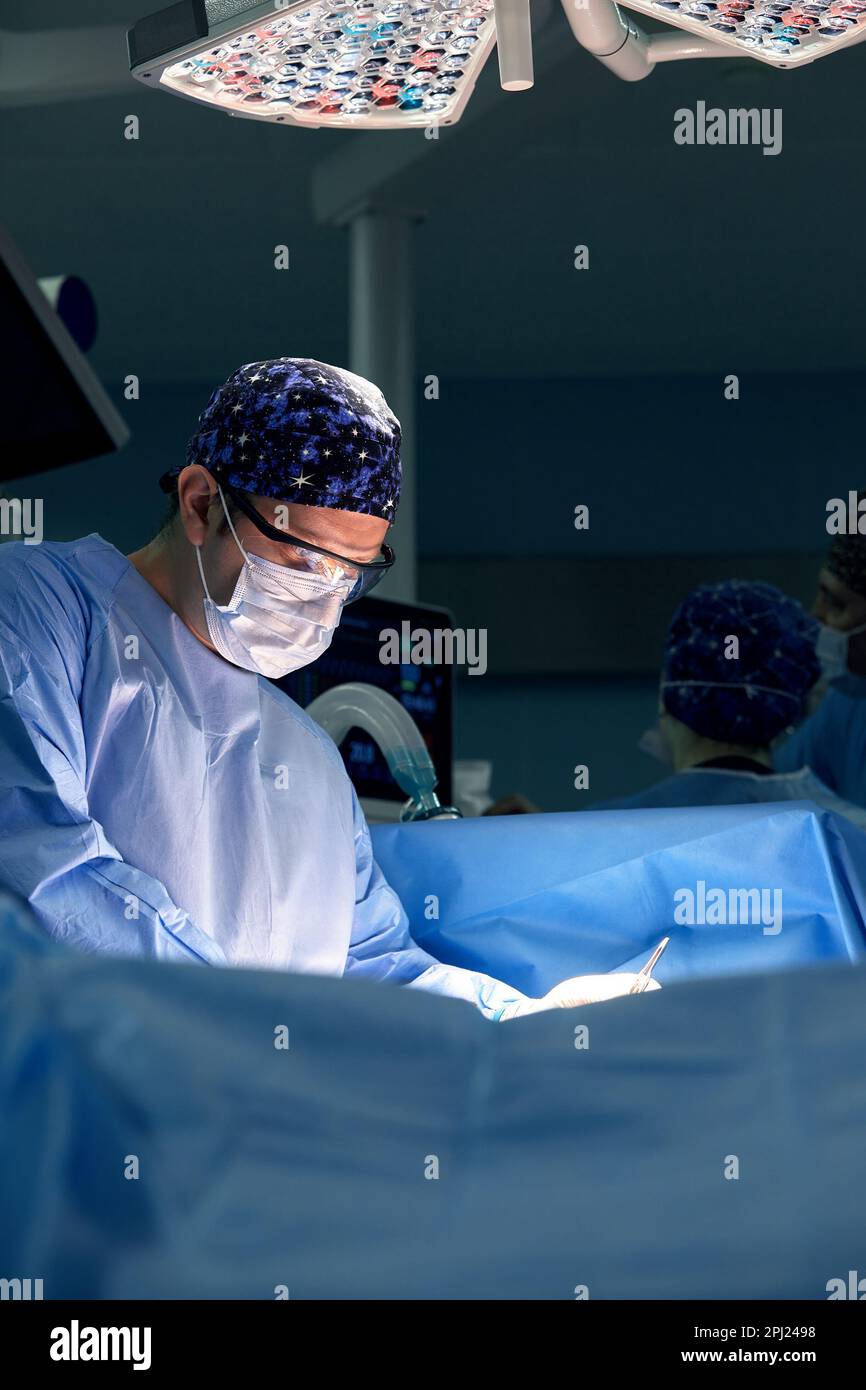 Group of surgeons doing surgery in hospital operating theater. Medical ...