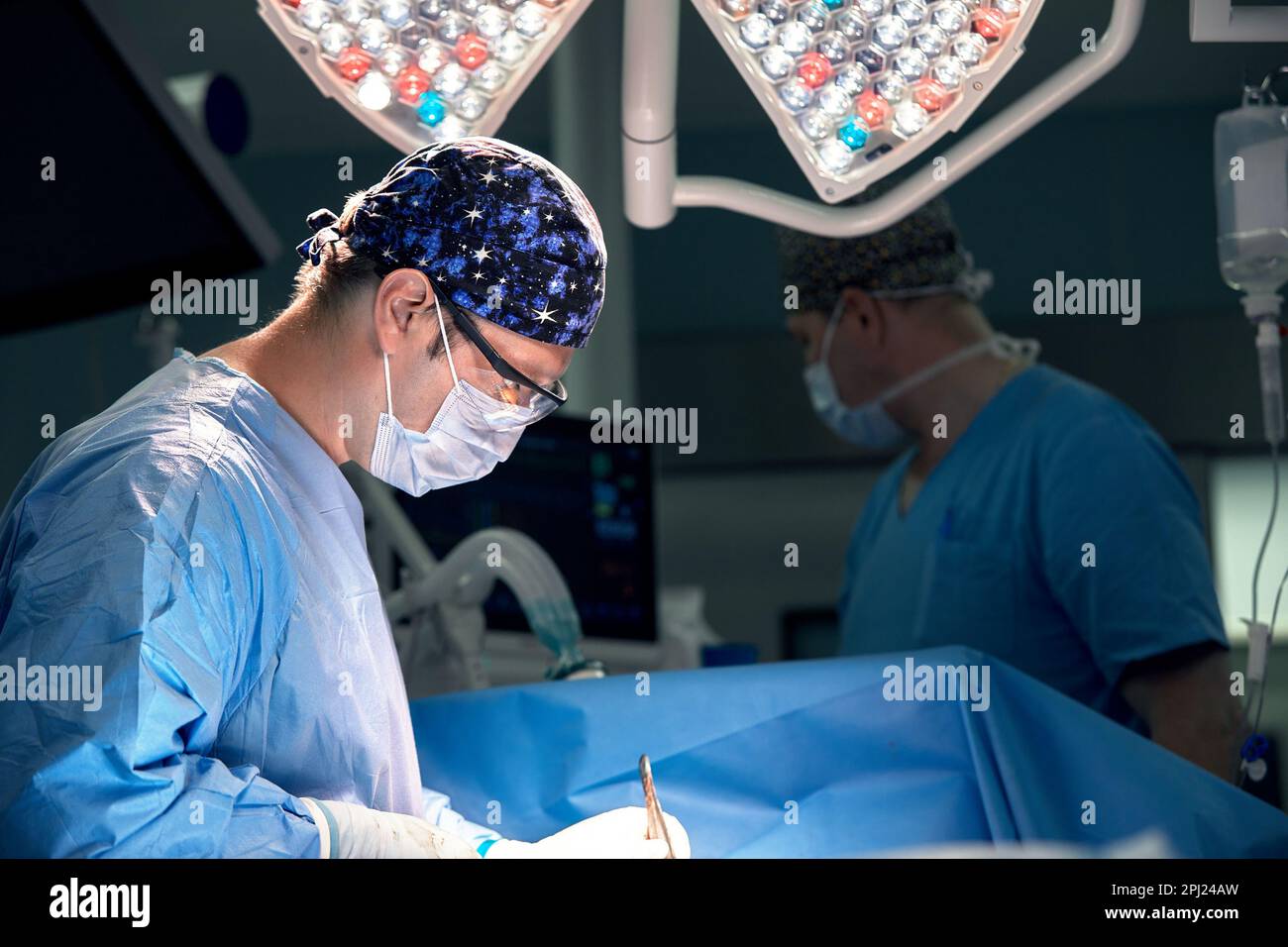 Group of surgeons doing surgery in a modern hospital operating room ...