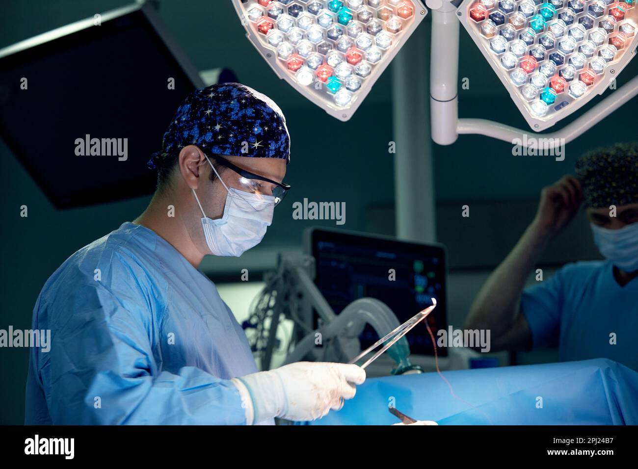 Group of surgeons doing surgery in a modern hospital operating room ...