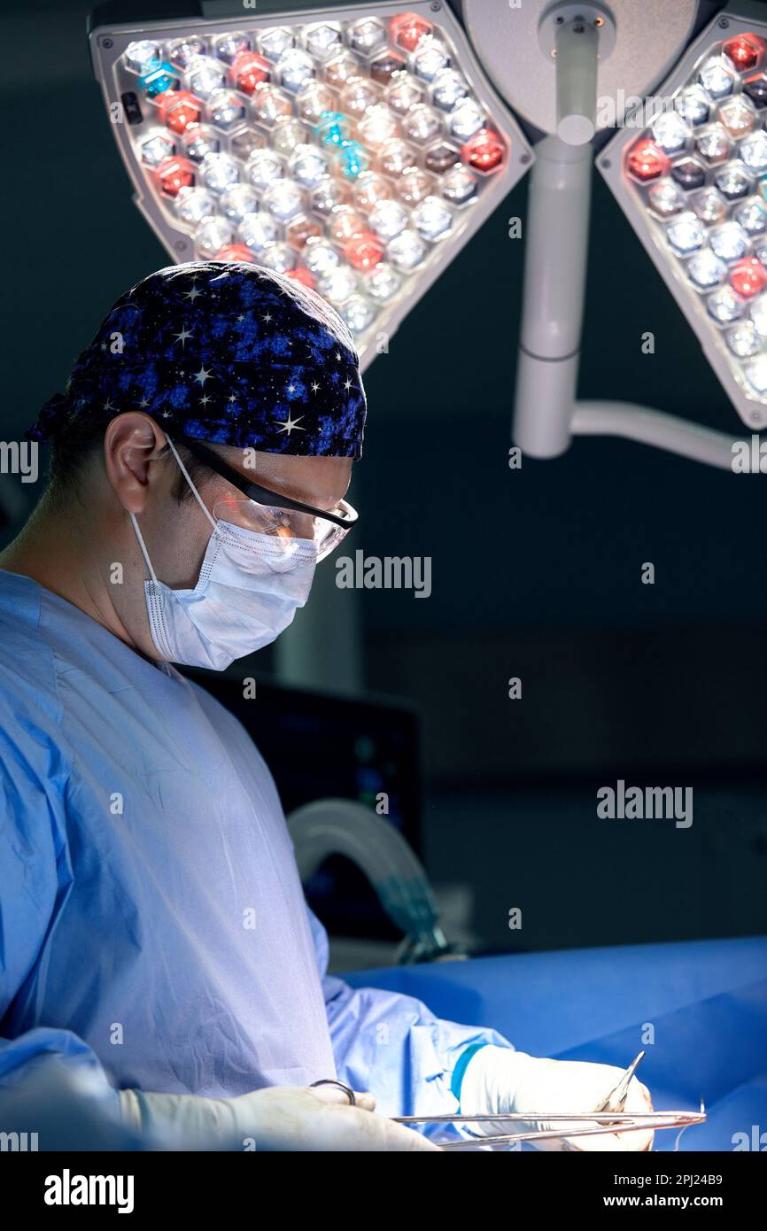 Group of surgeons doing surgery in hospital operating theater. Medical ...